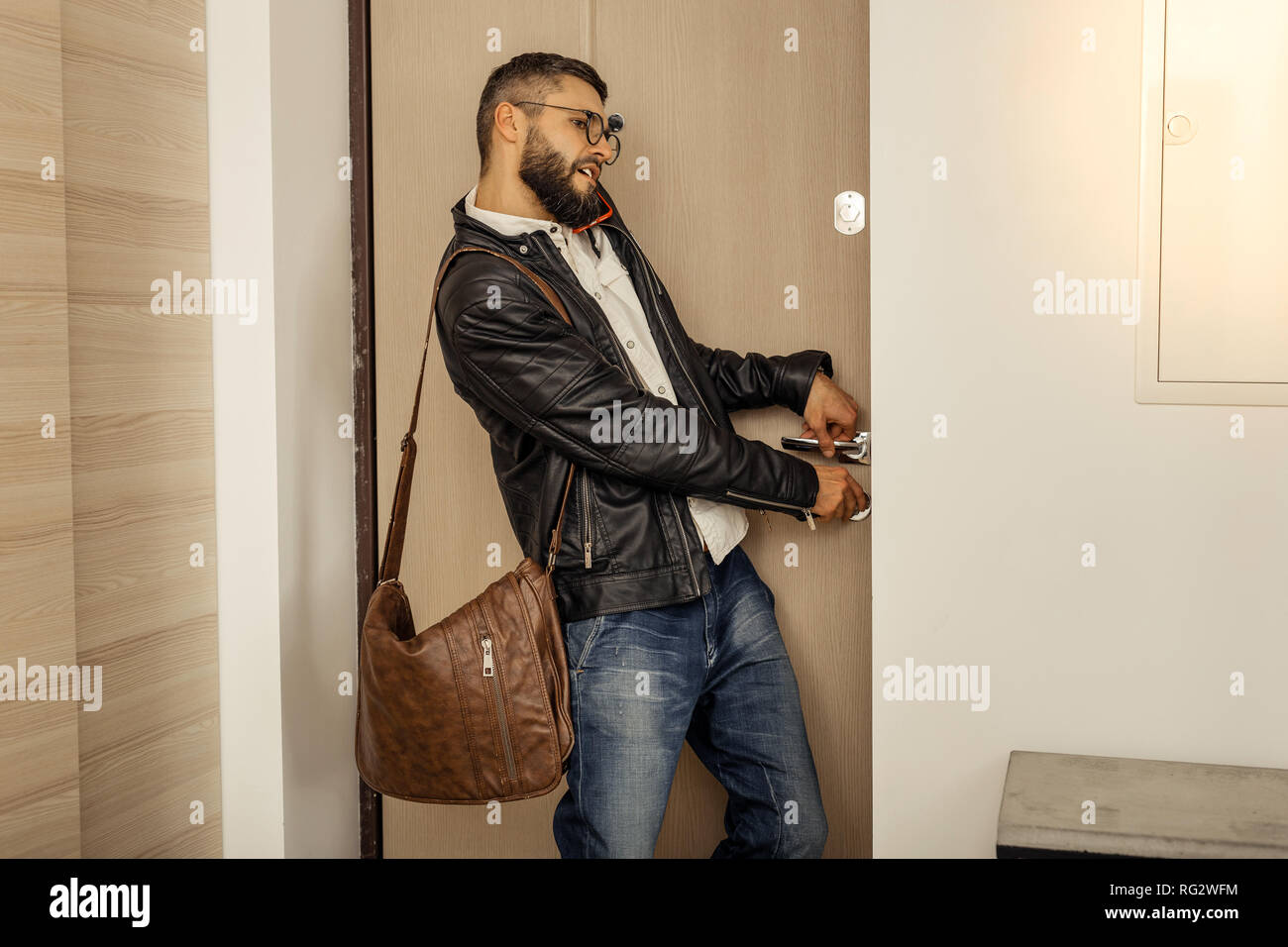 Handsome Tall Short Haired Bearded Man With A Bag Closing The Door