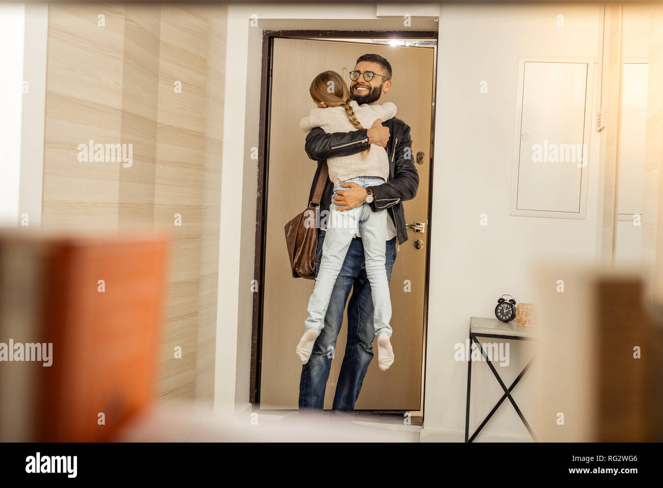Good-looking short-haired bearded man in eyeglasses smiling happily ...