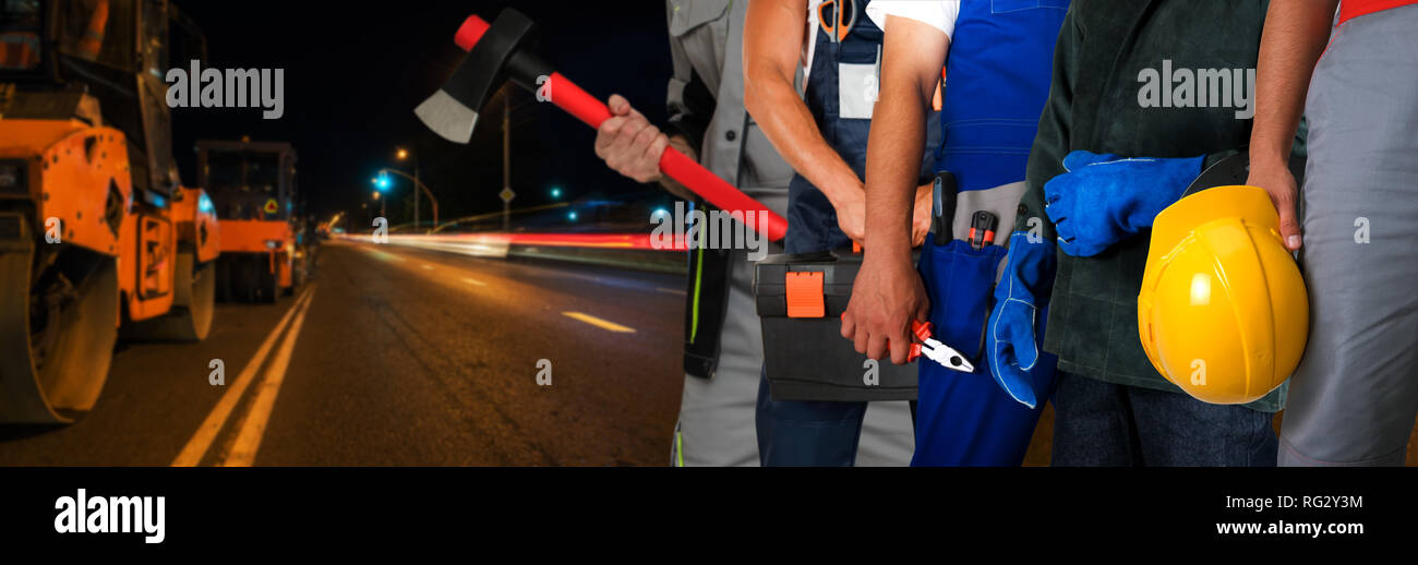 Builder workers with equipment repairing a road Stock Photo - Alamy