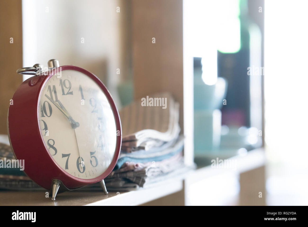 Vintage alarm clock on the shelf with dishes Stock Photo - Alamy