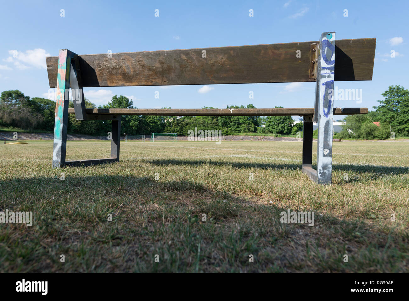 Old wooden bench overlooking soccer field with goal Stock Photo - Alamy
