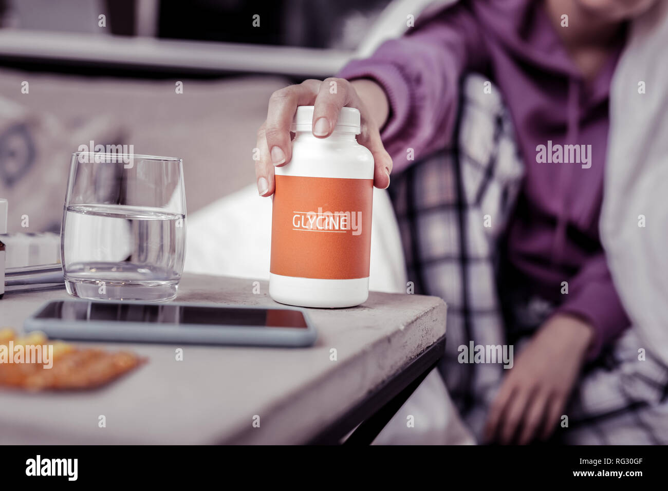 Focused photo on female hand that taking tablets Stock Photo - Alamy