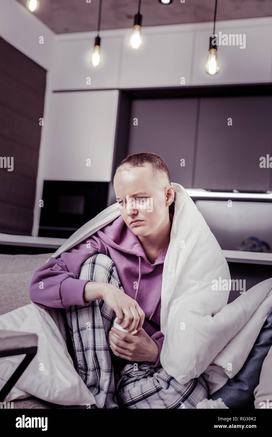 Upset bold female person being deep in thoughts Stock Photo - Alamy