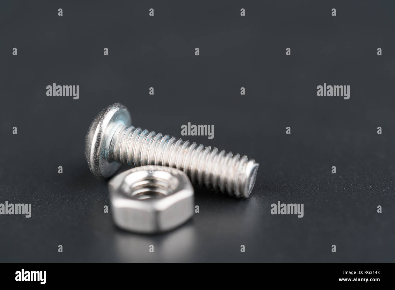 Screw and bolts on black background Stock Photo - Alamy