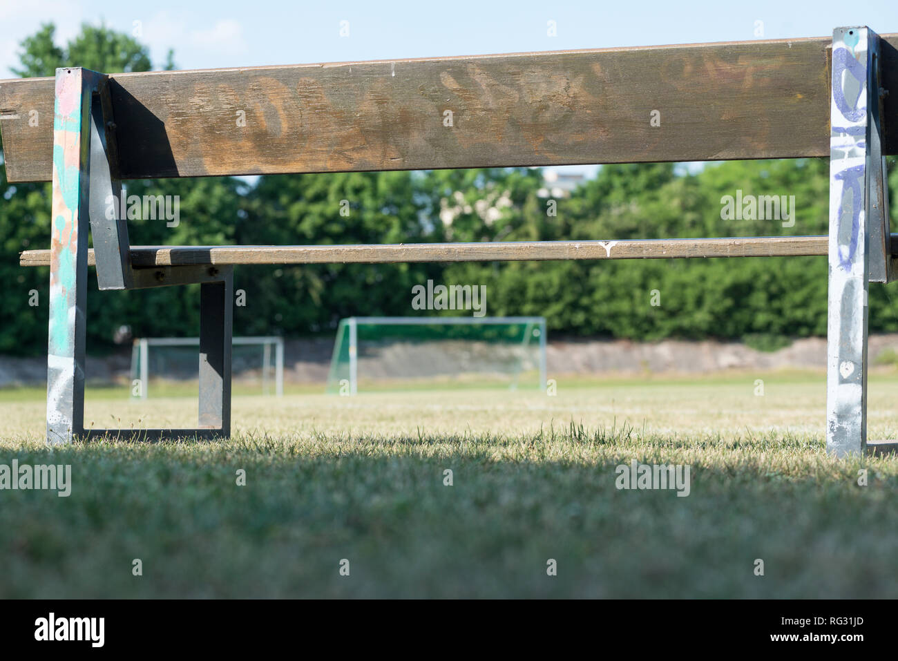 Old wooden bench overlooking soccer field Stock Photo - Alamy
