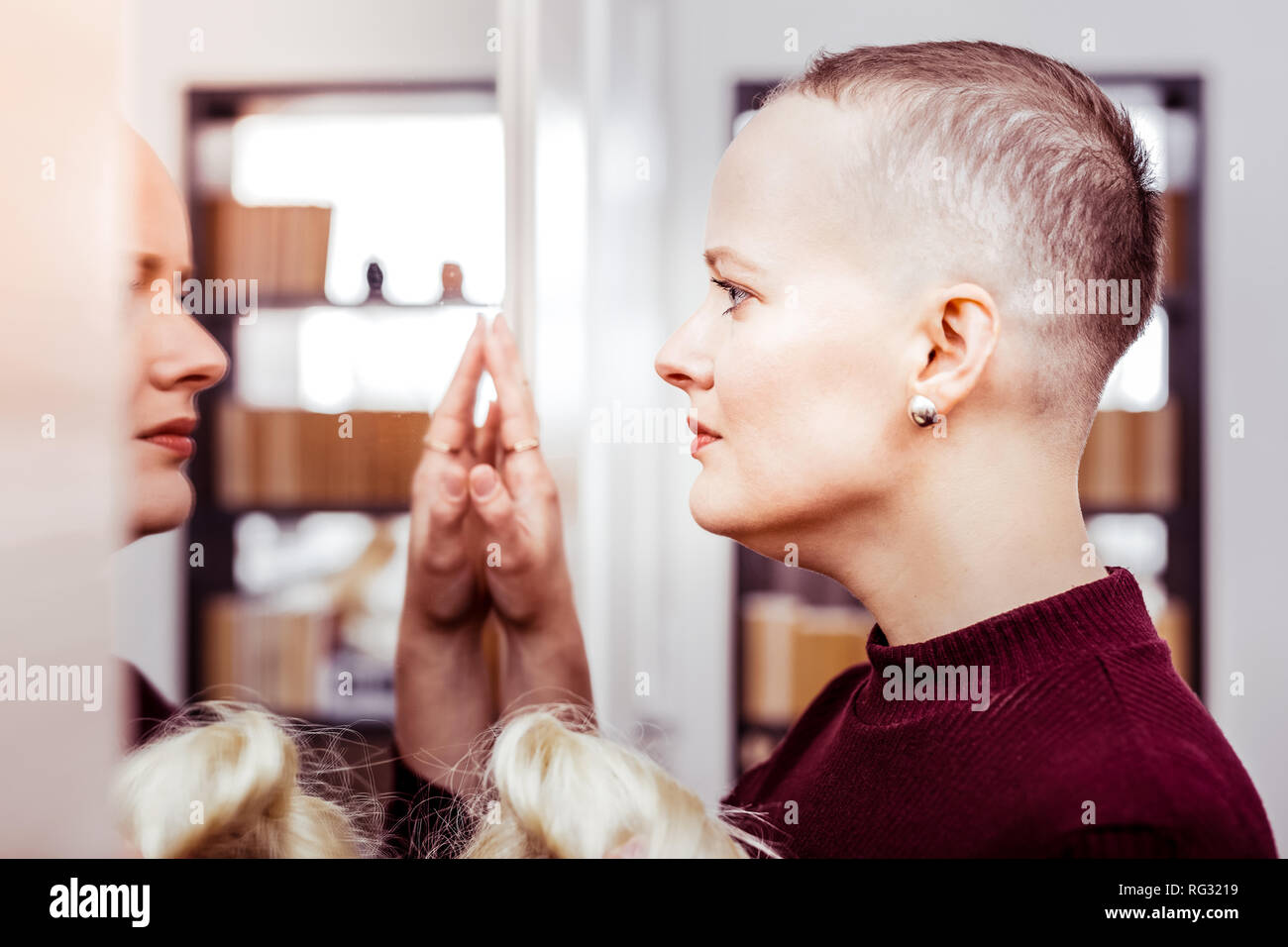 Concentrated bold female person being deep in thoughts Stock Photo - Alamy