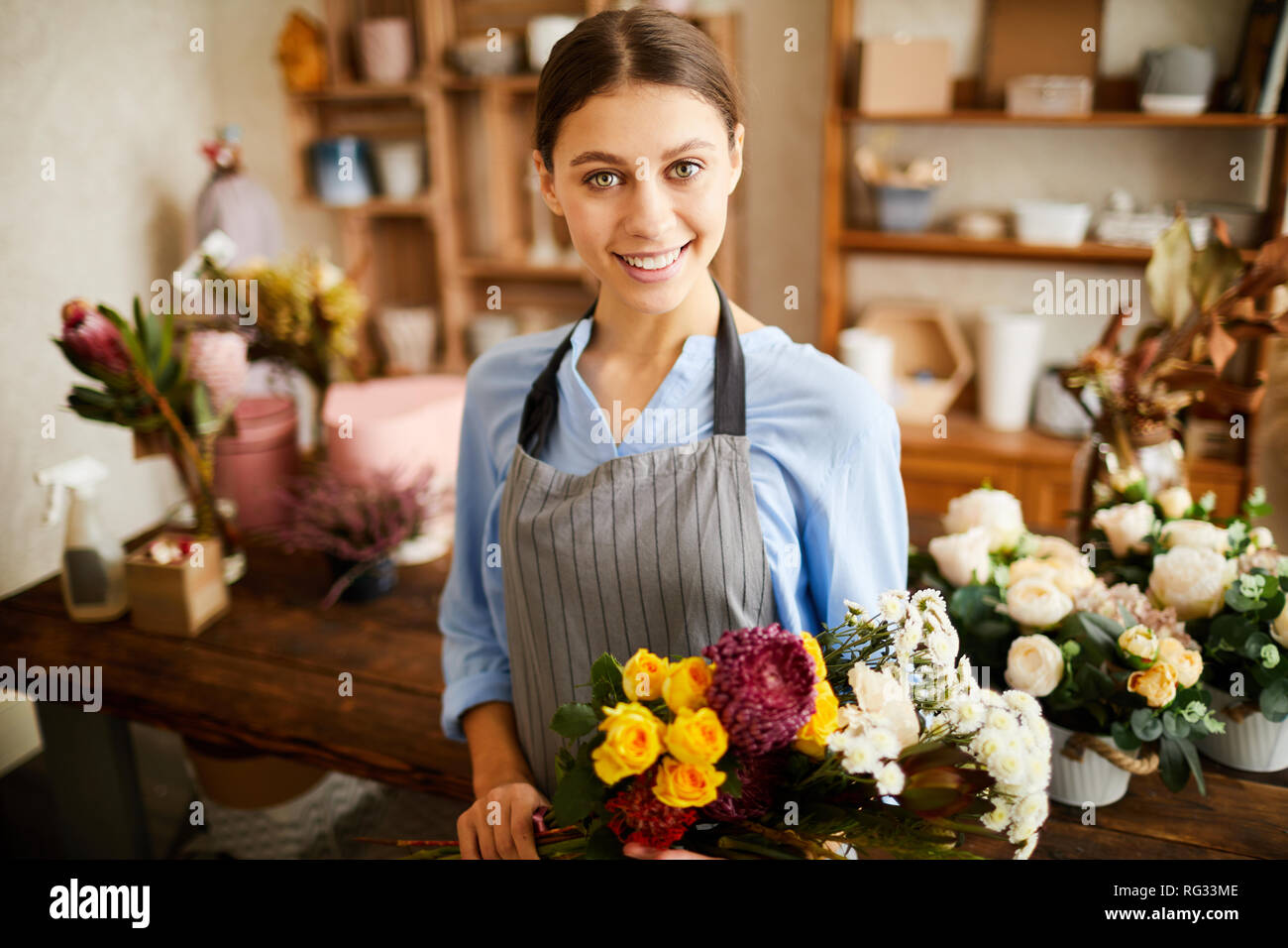 Beautiful Woman Posing in Flower Shop Stock Photo - Alamy