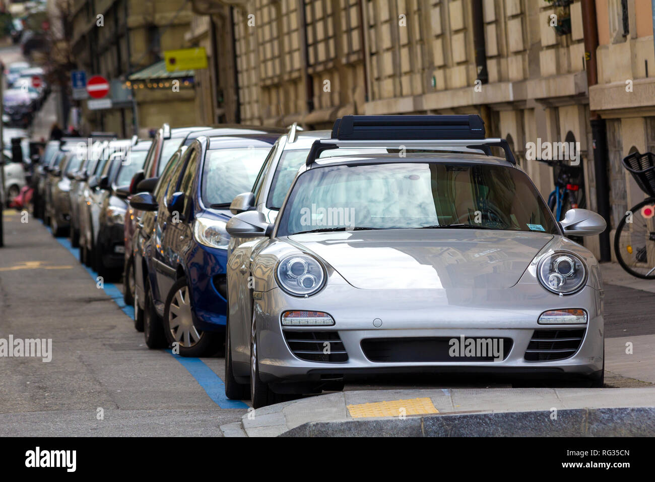 Long row of new shiny expensive luxurious cars parked along urban ...