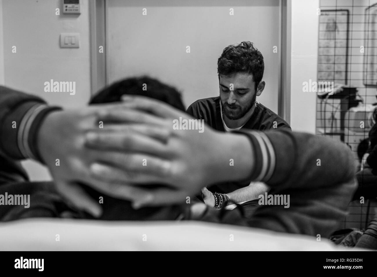 A white italian man, working as a phisiotherapist is photographed while ...