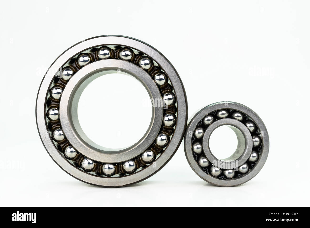 Small and large ball bearing close up, isolated on white background ...