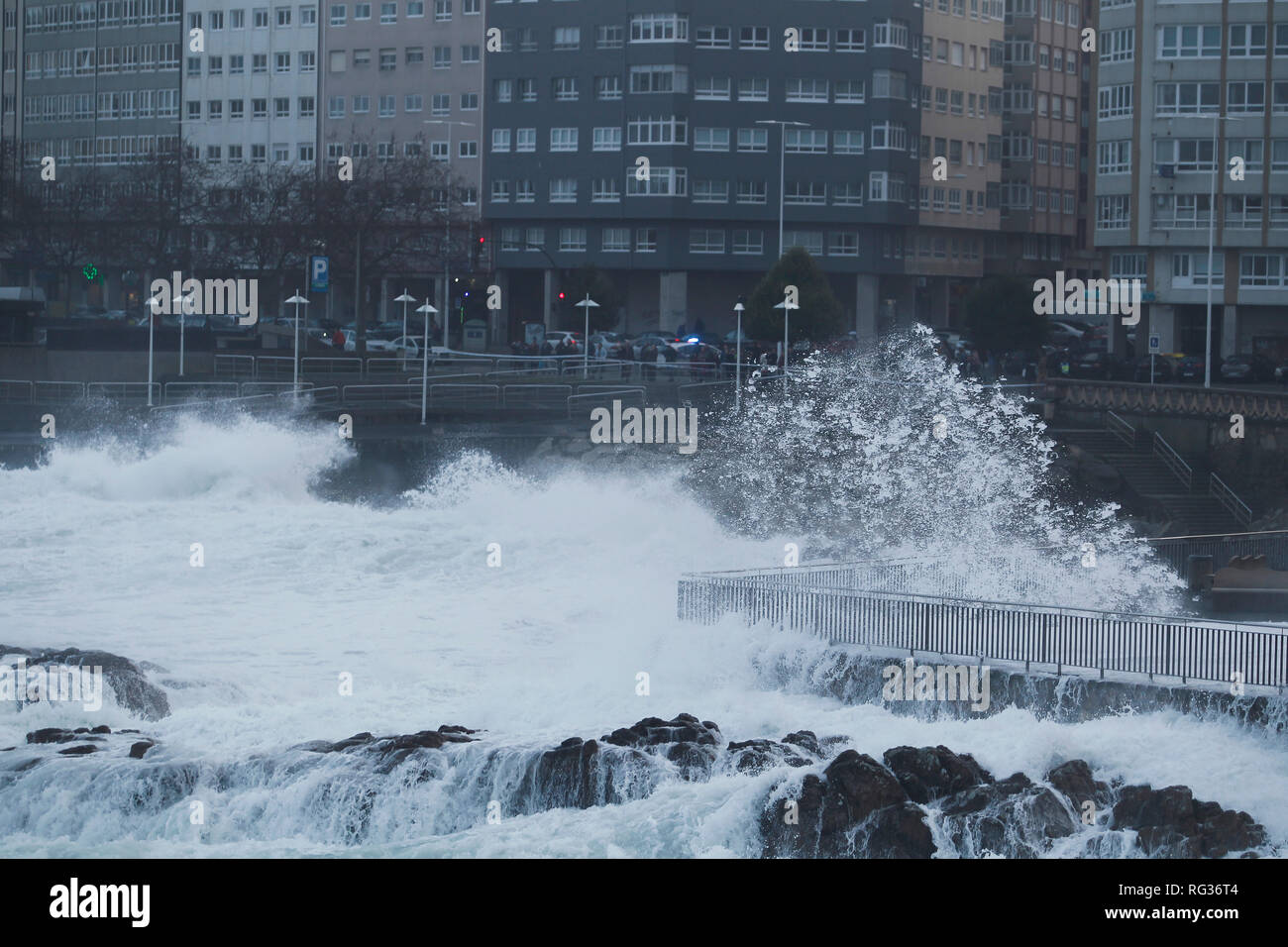 Big waves breaking in the Orzan inlet with the buildings of the city in ...