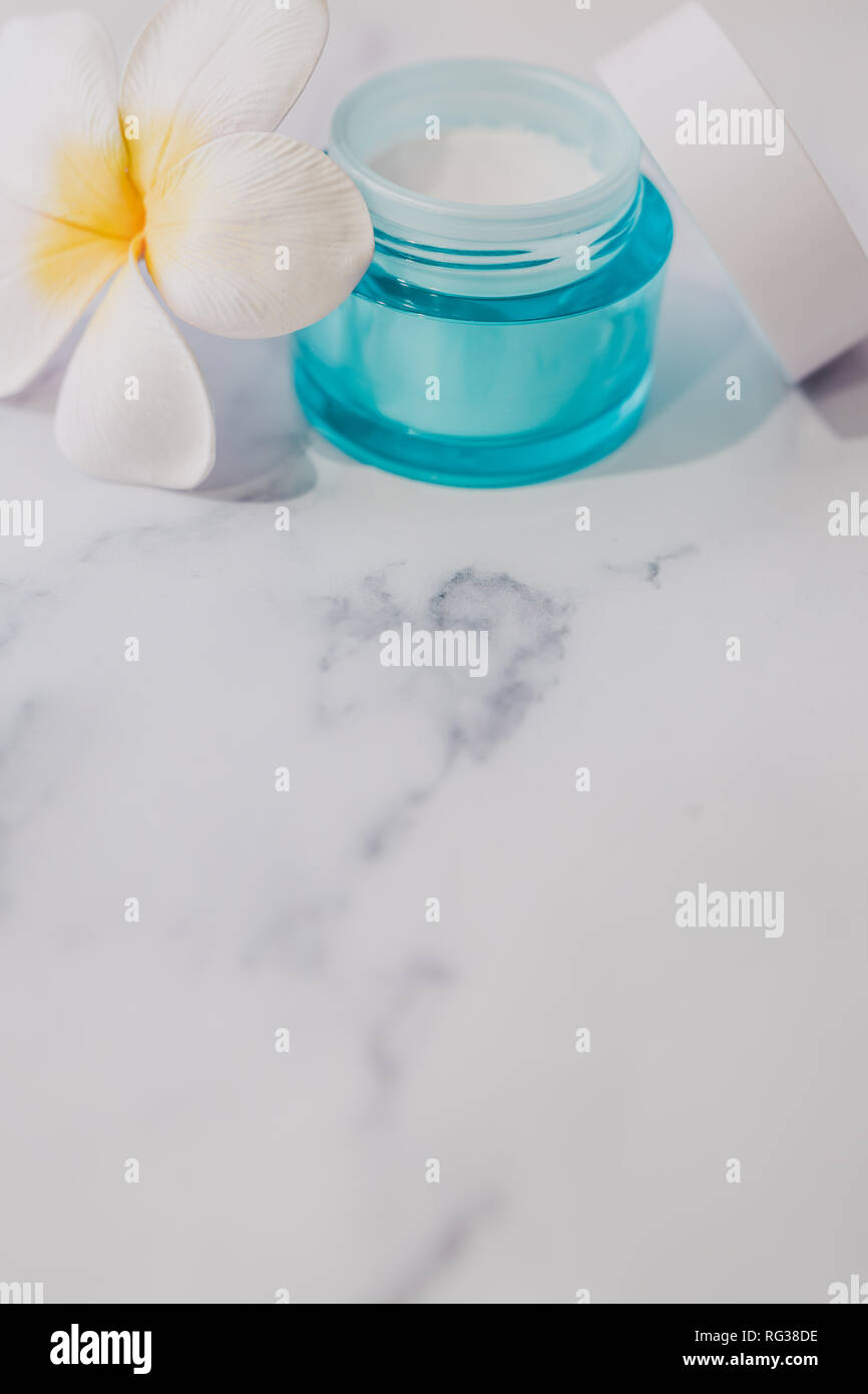 spa and skincare treatments concept, moisturiser pot on marble table ...