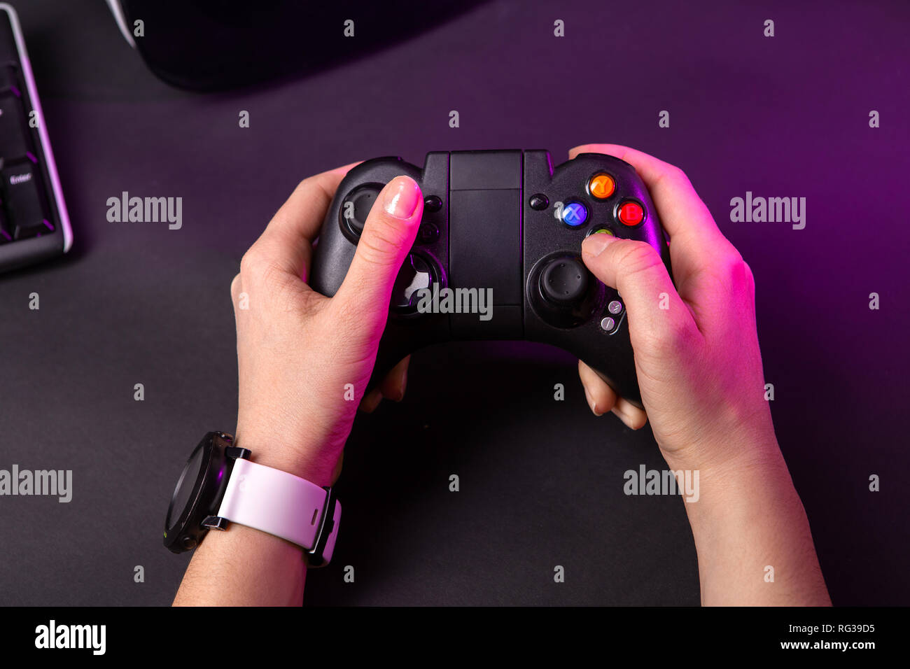 Female hands playing a computer game with a game joystick. Gamer ...