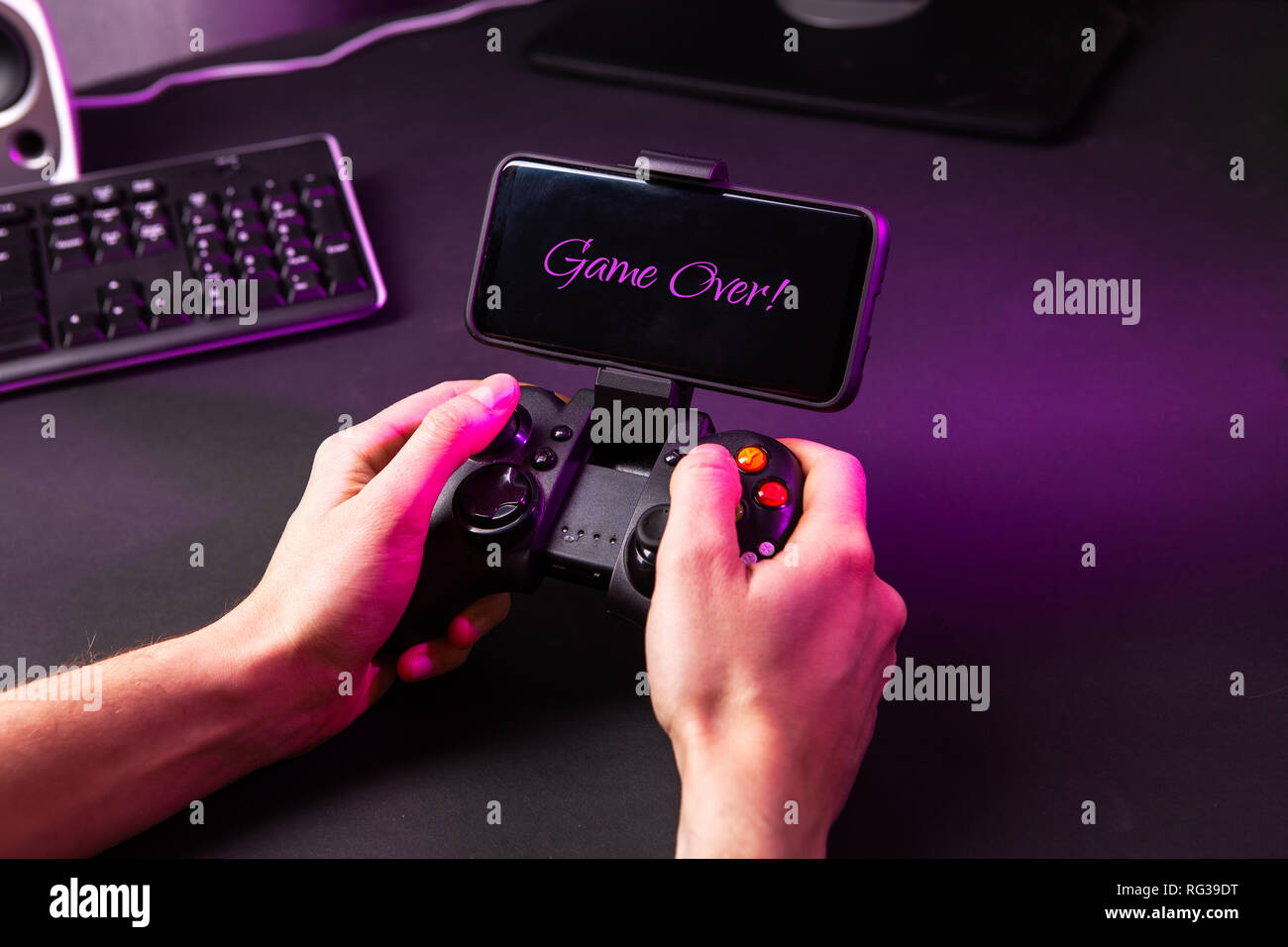 Man hands playing a computer game with a game joystick. Gamer workspace ...