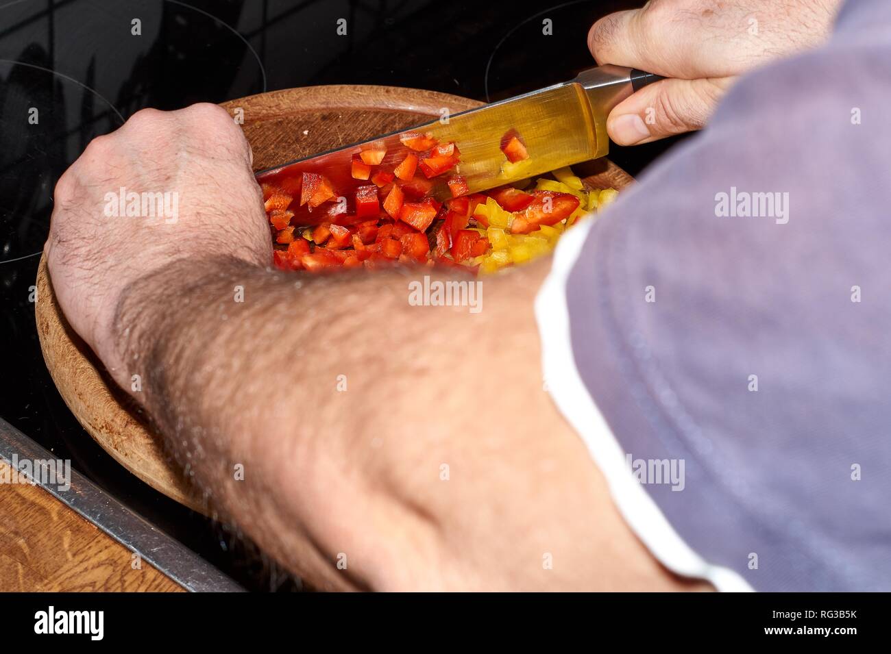 Yellow and red peppers Capsicum cut with a knife on a board Stock Photo ...