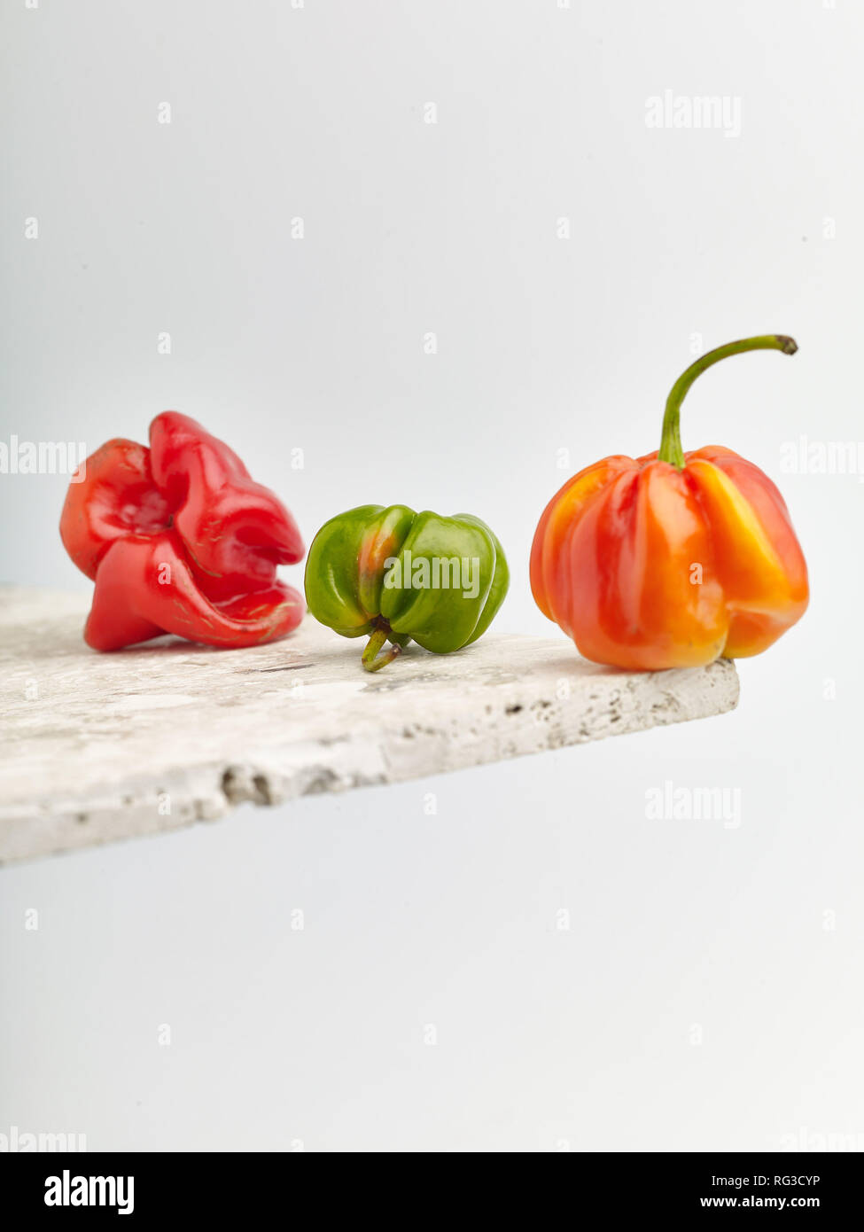 Scotch bonnet pepper and mottled marble surface against light ...