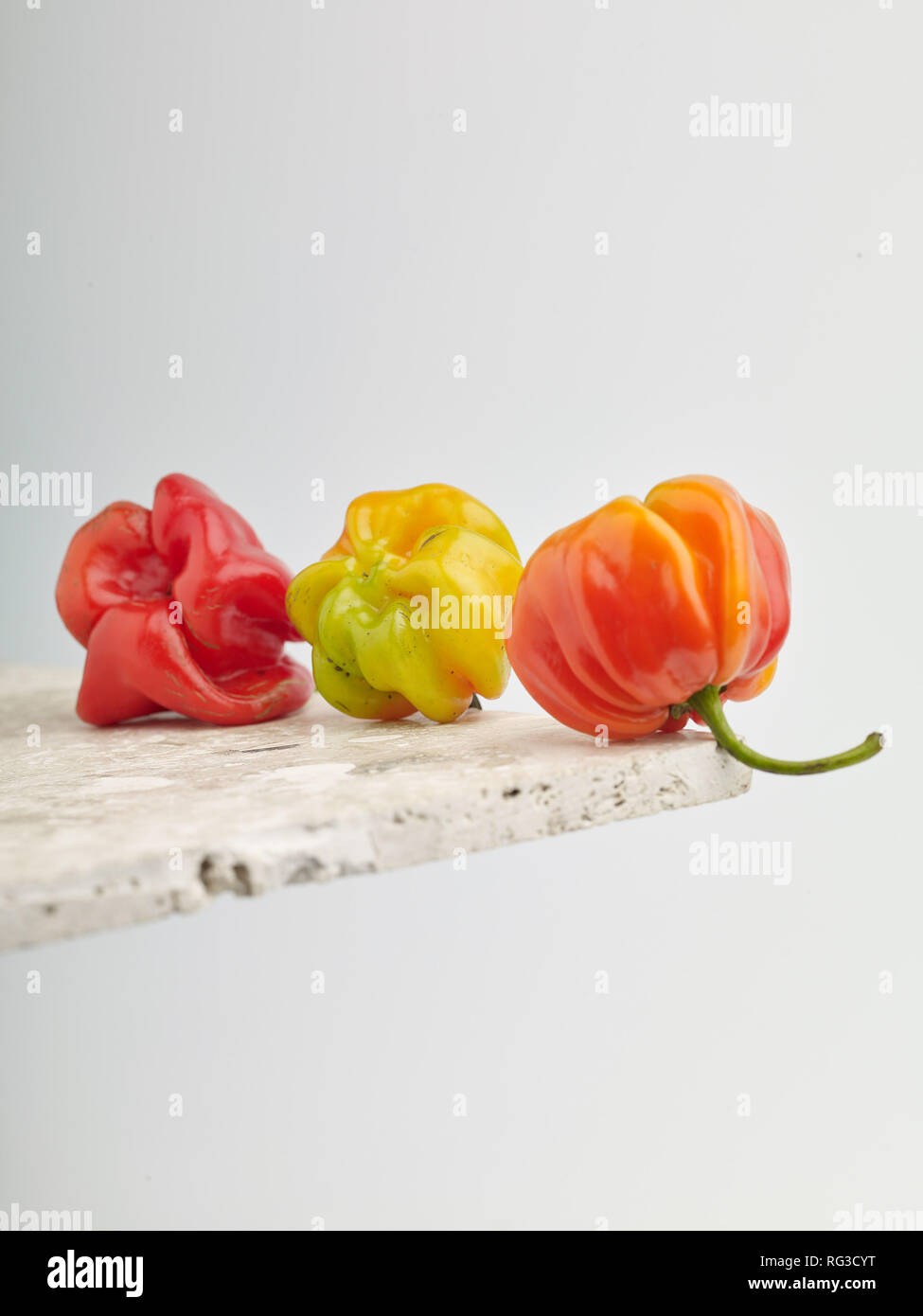 Scotch bonnet pepper and mottled marble surface against light ...