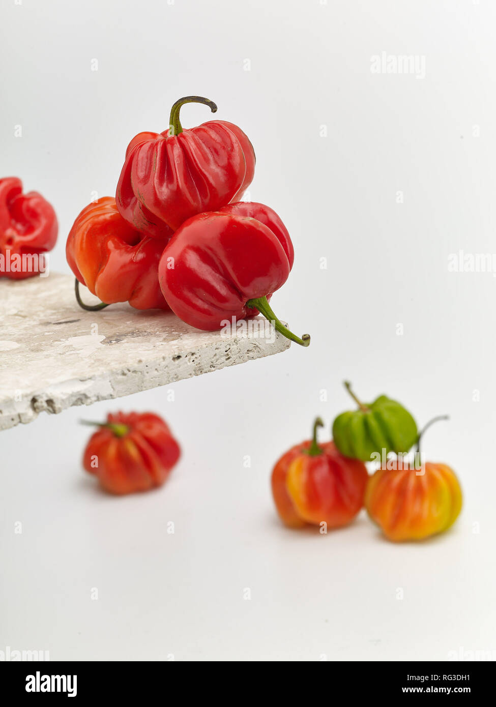 Scotch bonnet pepper and mottled marble surface against light ...
