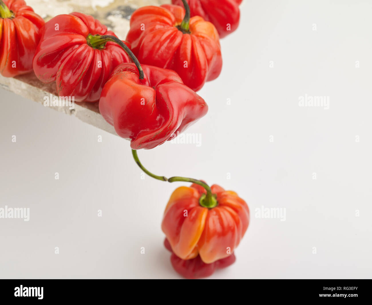 Scotch bonnet pepper and mottled marble surface against light ...