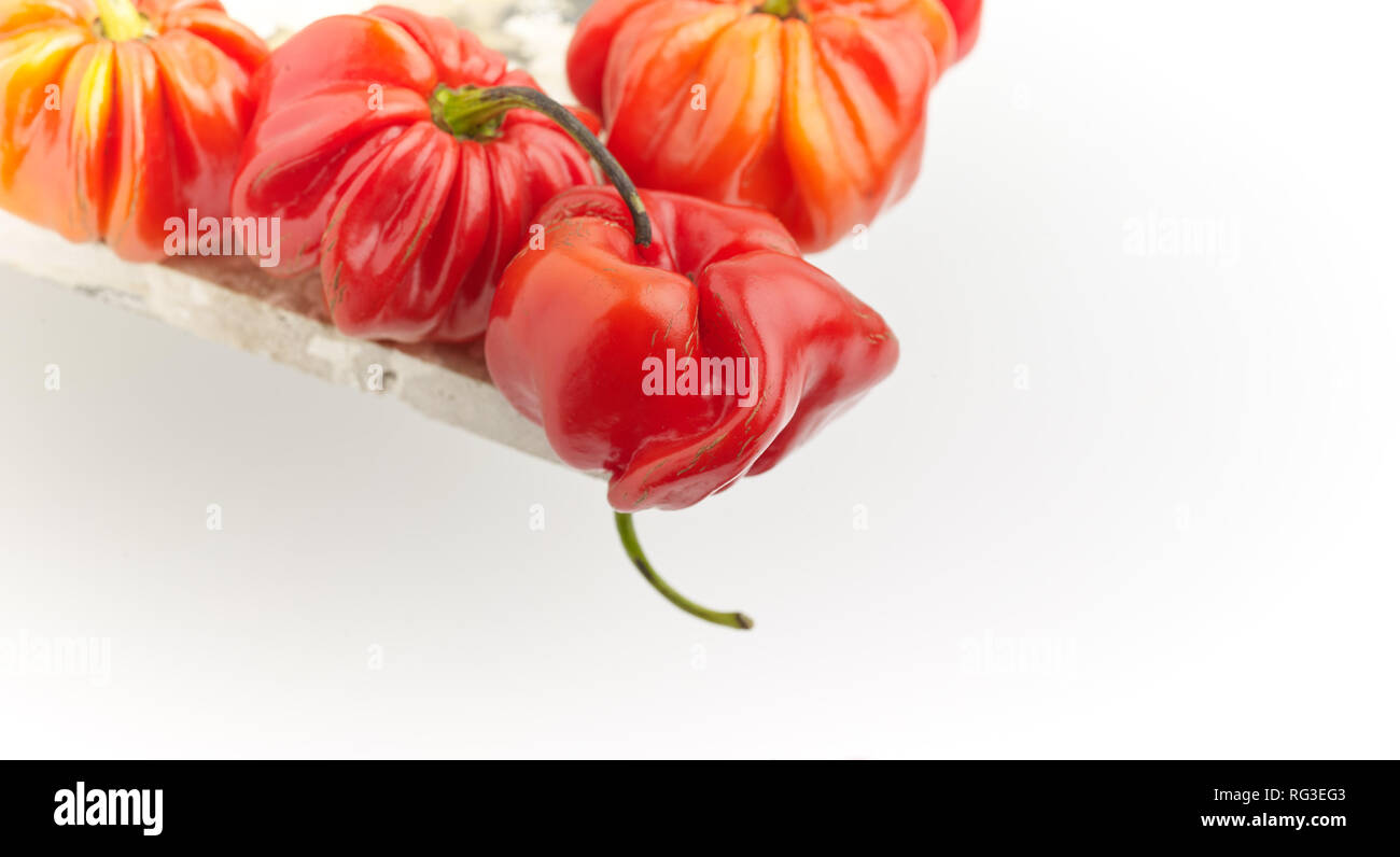Scotch bonnet pepper and mottled marble surface against light ...