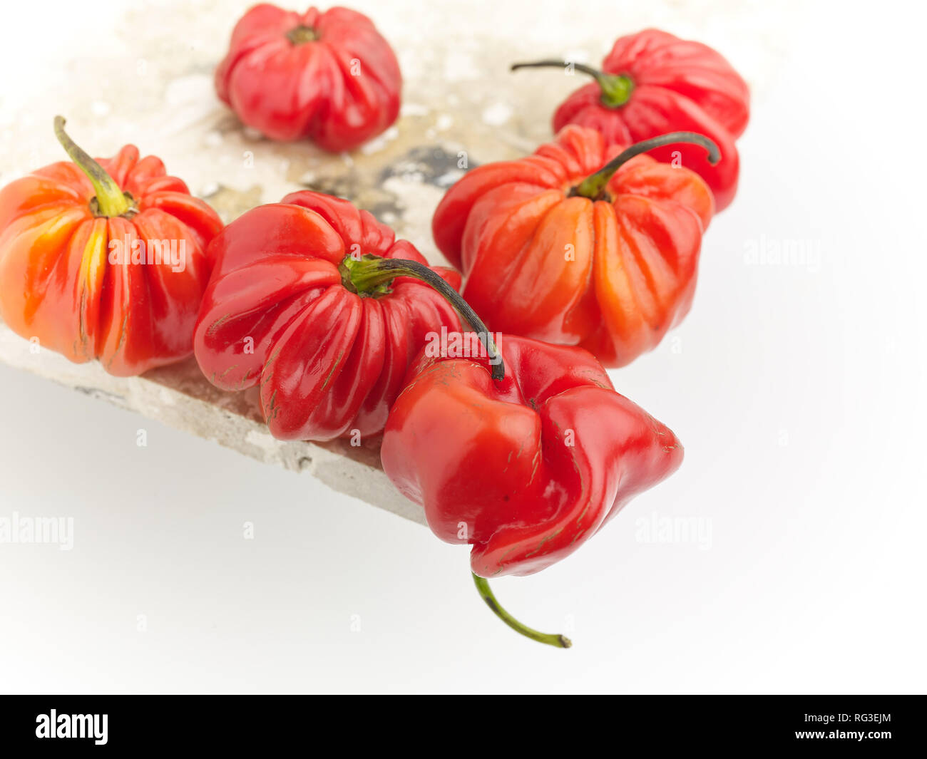 Scotch bonnet pepper and mottled marble surface against light ...