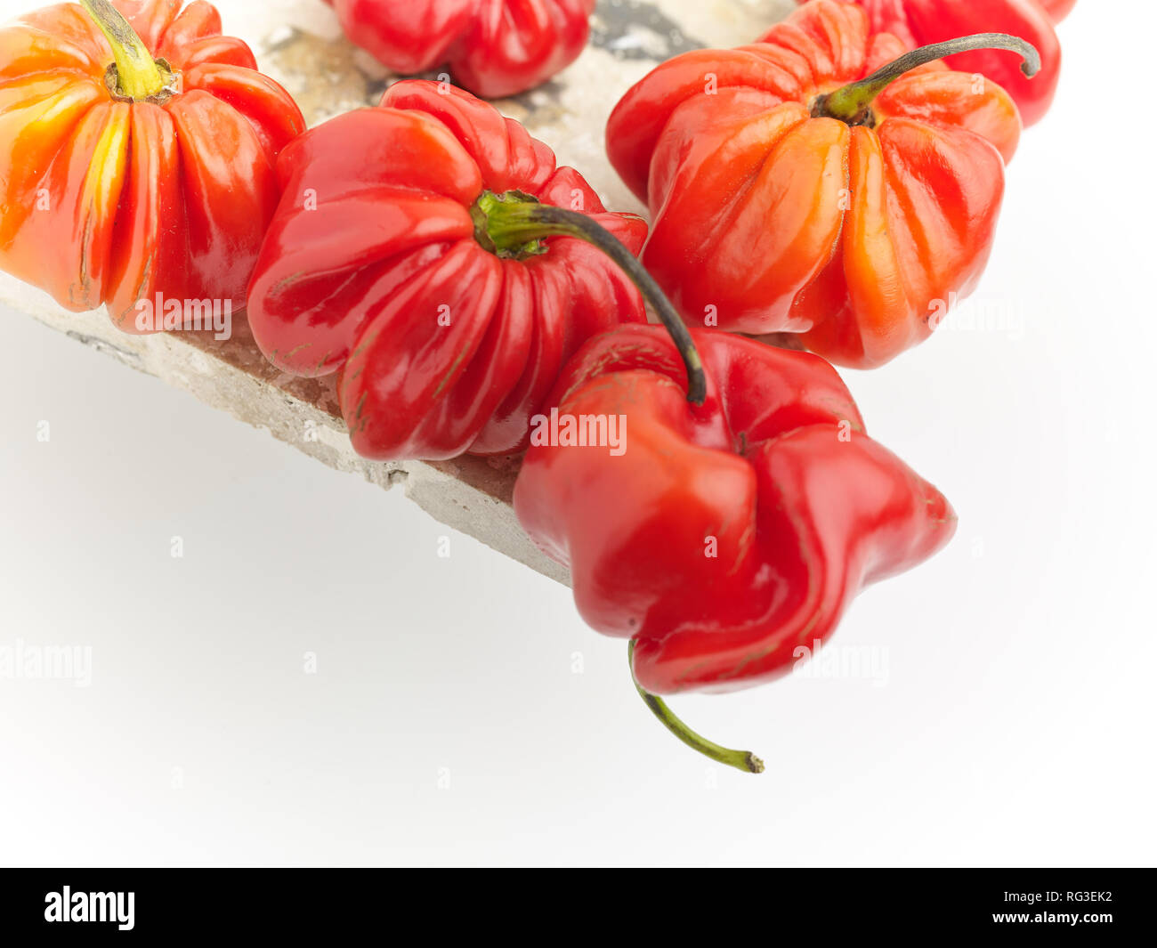 Scotch bonnet pepper and mottled marble surface against light ...