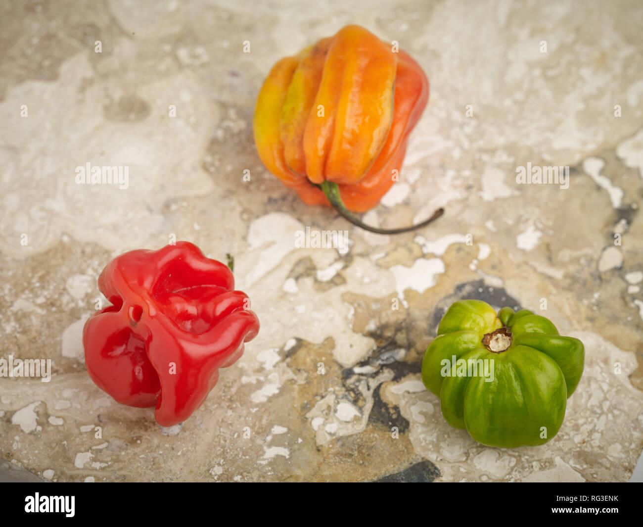 Scotch bonnet pepper and mottled marble surface against light ...