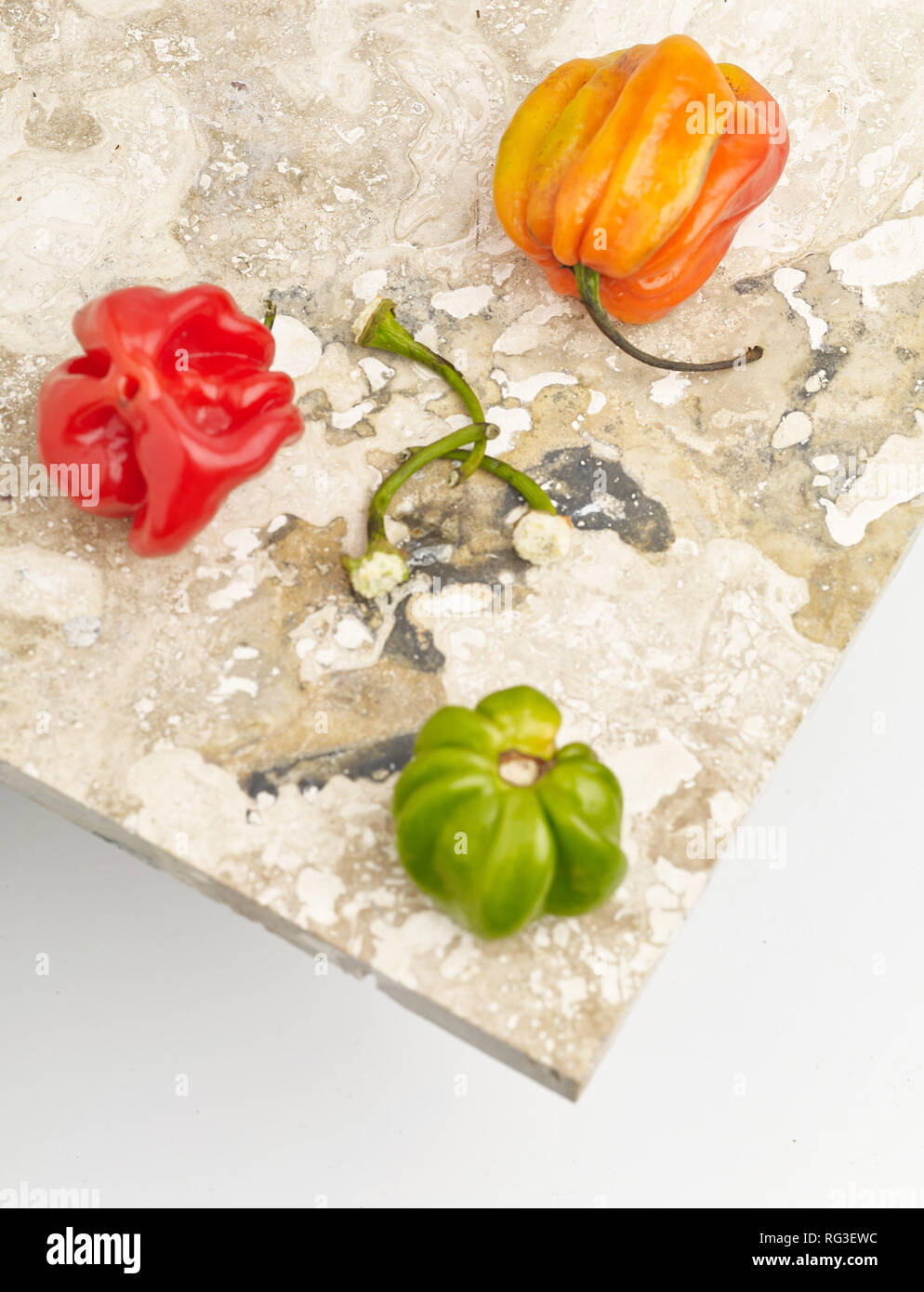 Scotch bonnet pepper and mottled marble surface against light ...