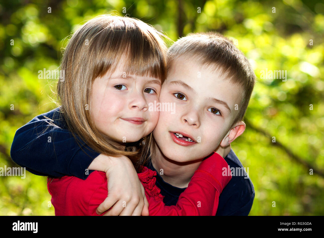 Two cute blond funny happy smiling children siblings, young boy brother ...