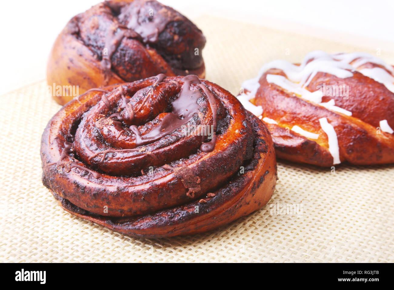 Freshly baked homemade sweet rolls with cinnamon on white background ...