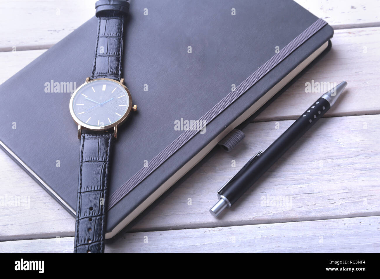 Accessories for business. Watch, notepad and pen on wooden background ...