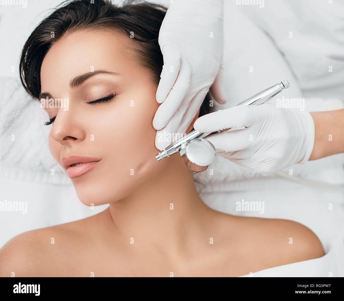 face of beautiful woman while procedure jet peeling, facial treatment ...