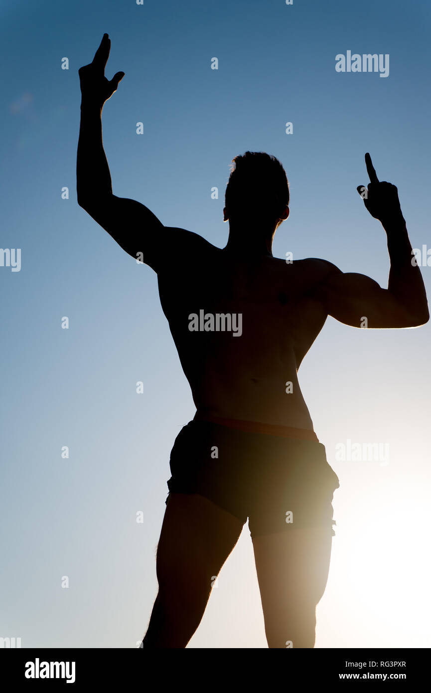 Fitness and sport concept. Sportsman raising hands with biceps, triceps ...
