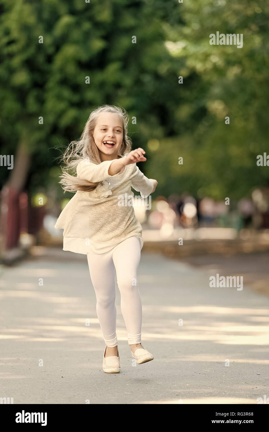 Child happy and cheerful enjoy walk in park. Childhood concept. Kid ...