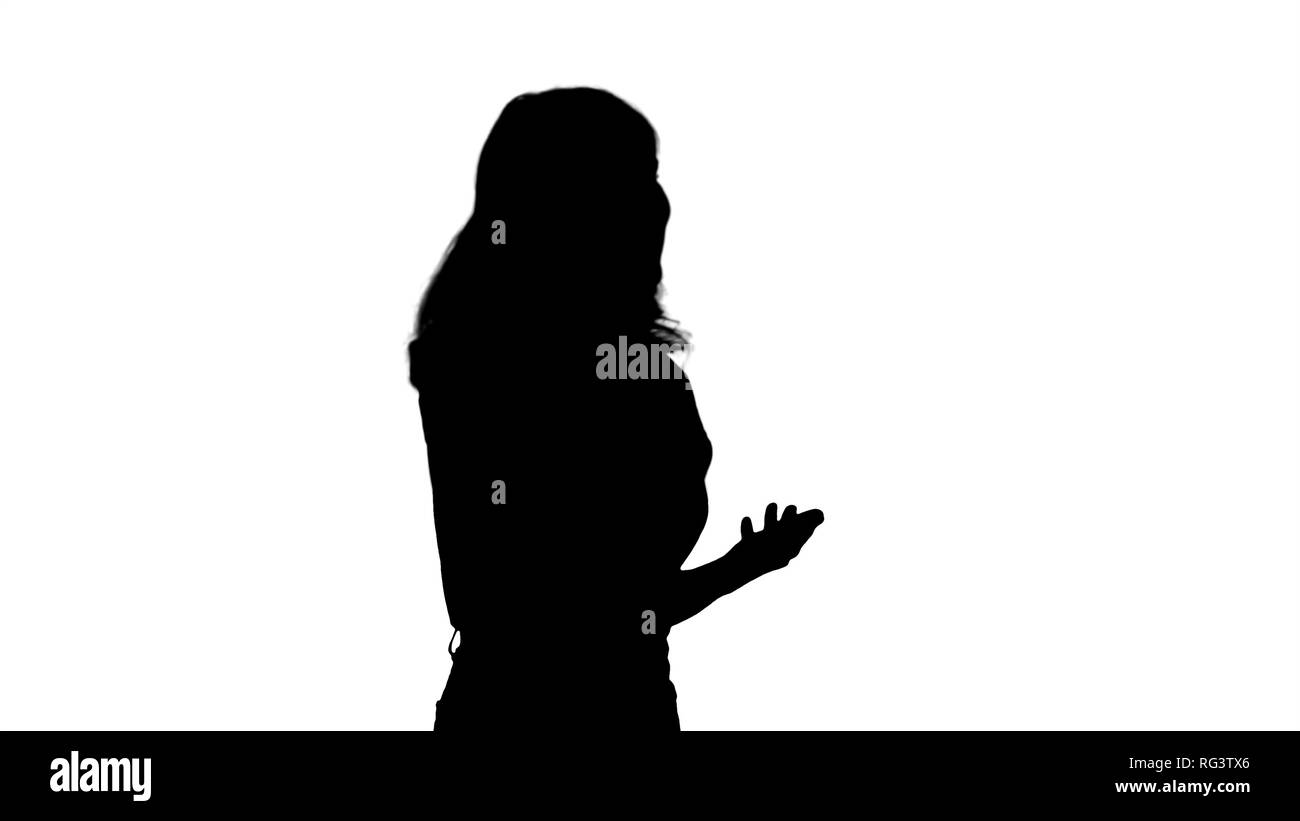 Medium shot. Side view. Silhouette Pretty woman talking on the phone ...