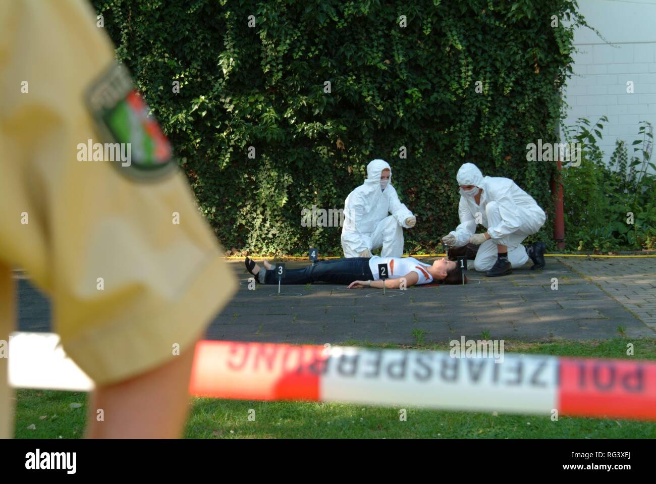 DEU, Germany, NRW: Forensic detectiv search a crime scene. The officers ...