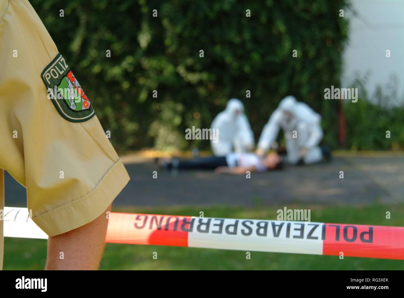 DEU, Germany, NRW: Forensic detectiv search a crime scene. The officers ...