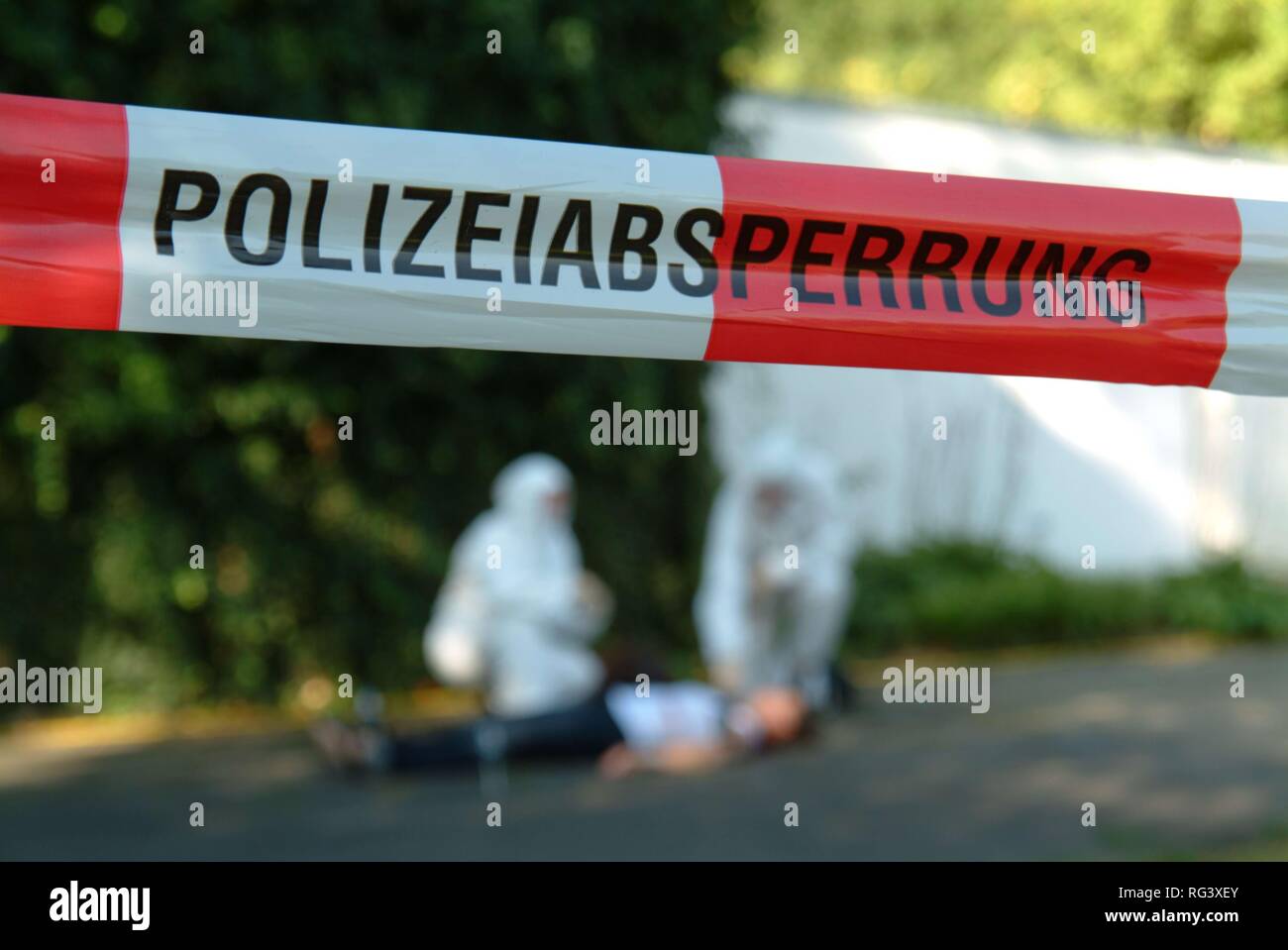 DEU, Germany, NRW: Forensic detectiv search a crime scene. The officers ...