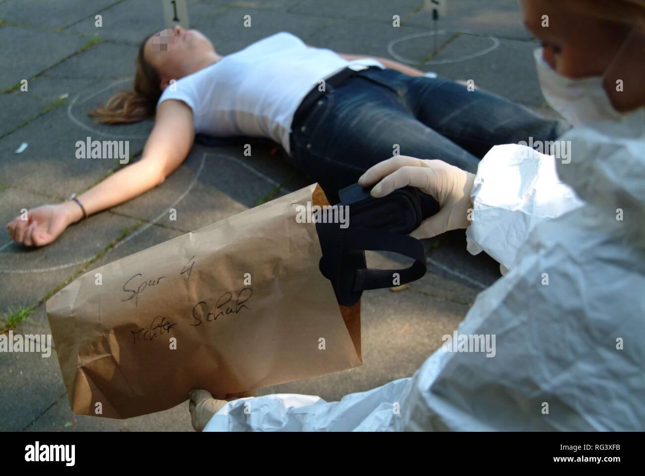 DEU, Germany, NRW: Forensic detectiv search a crime scene. The officers ...