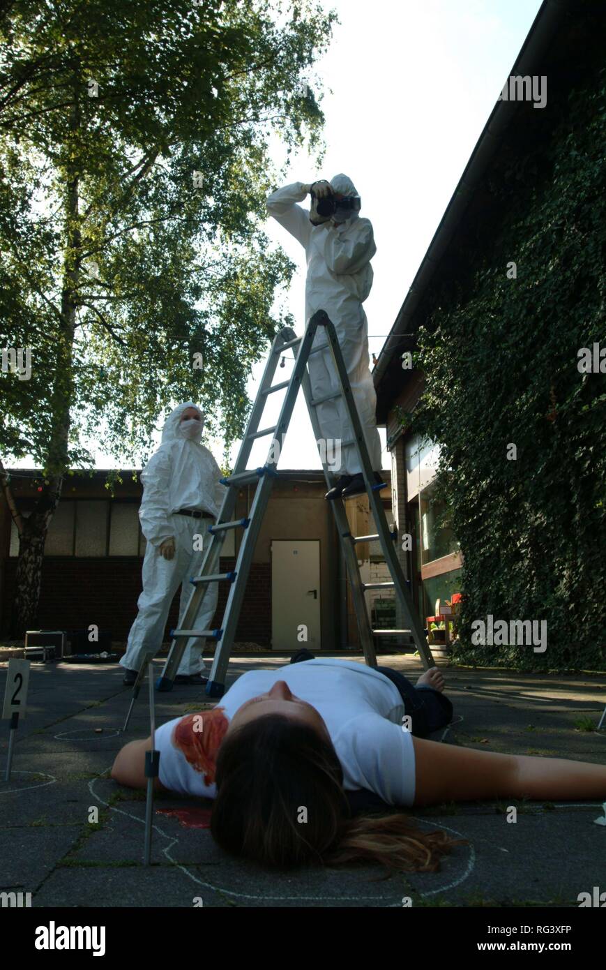 DEU, Germany, NRW: Forensic detectiv search a crime scene. The officers ...