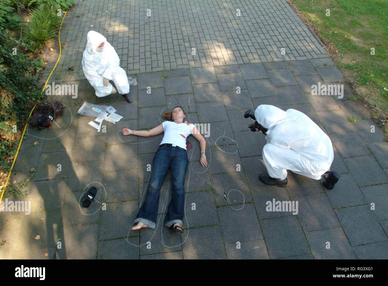 DEU, Germany, NRW: Forensic detectiv search a crime scene. The officers ...