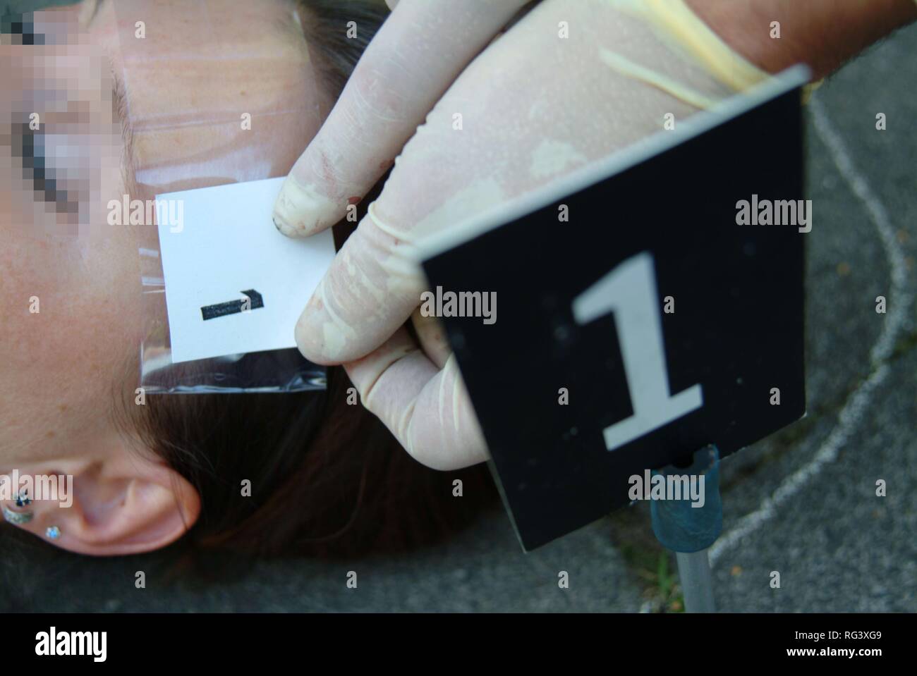 DEU, Germany, NRW: Forensic detectiv search a crime scene. The officers ...