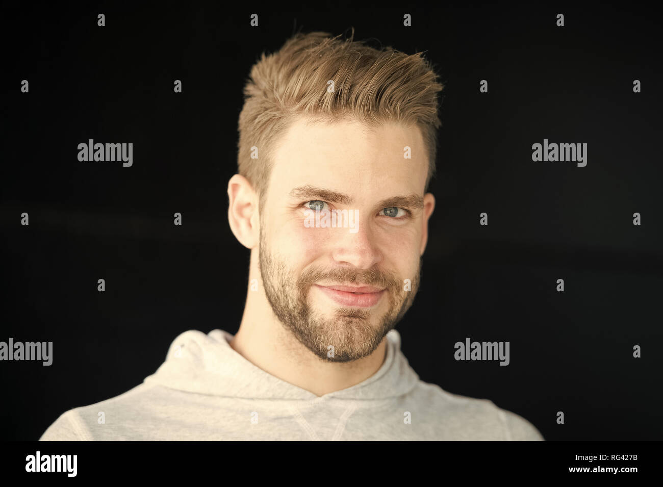 Man with bristle on smiling face, black background. Metrosexual concept ...