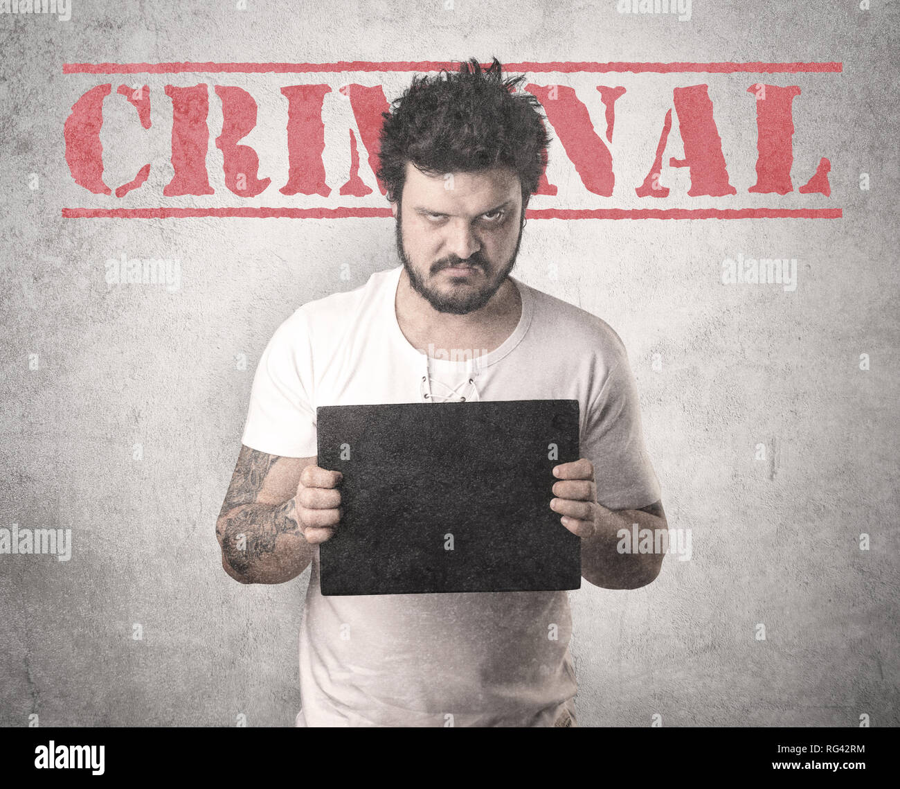 Caught gangster with criminal background Stock Photo - Alamy