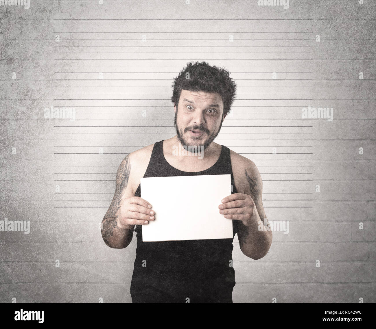 Gangster in front of a wall with table on his hand Stock Photo - Alamy