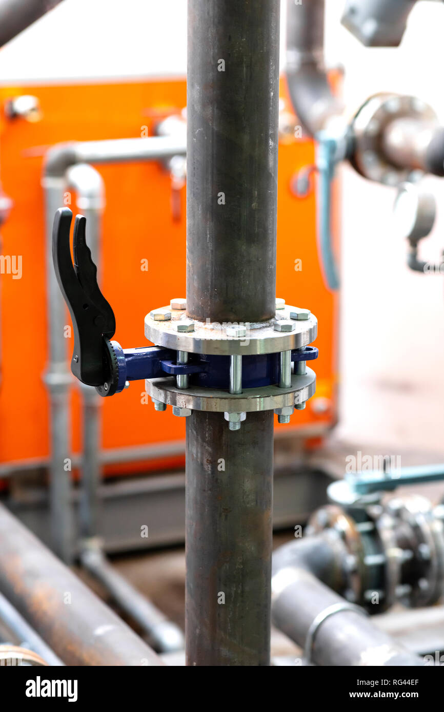 steel pipe with the control key, orange table as background and other ...