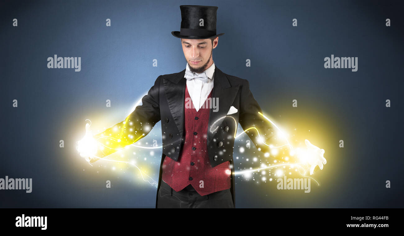 Magician holding his sparkling power between his two hand Stock Photo ...