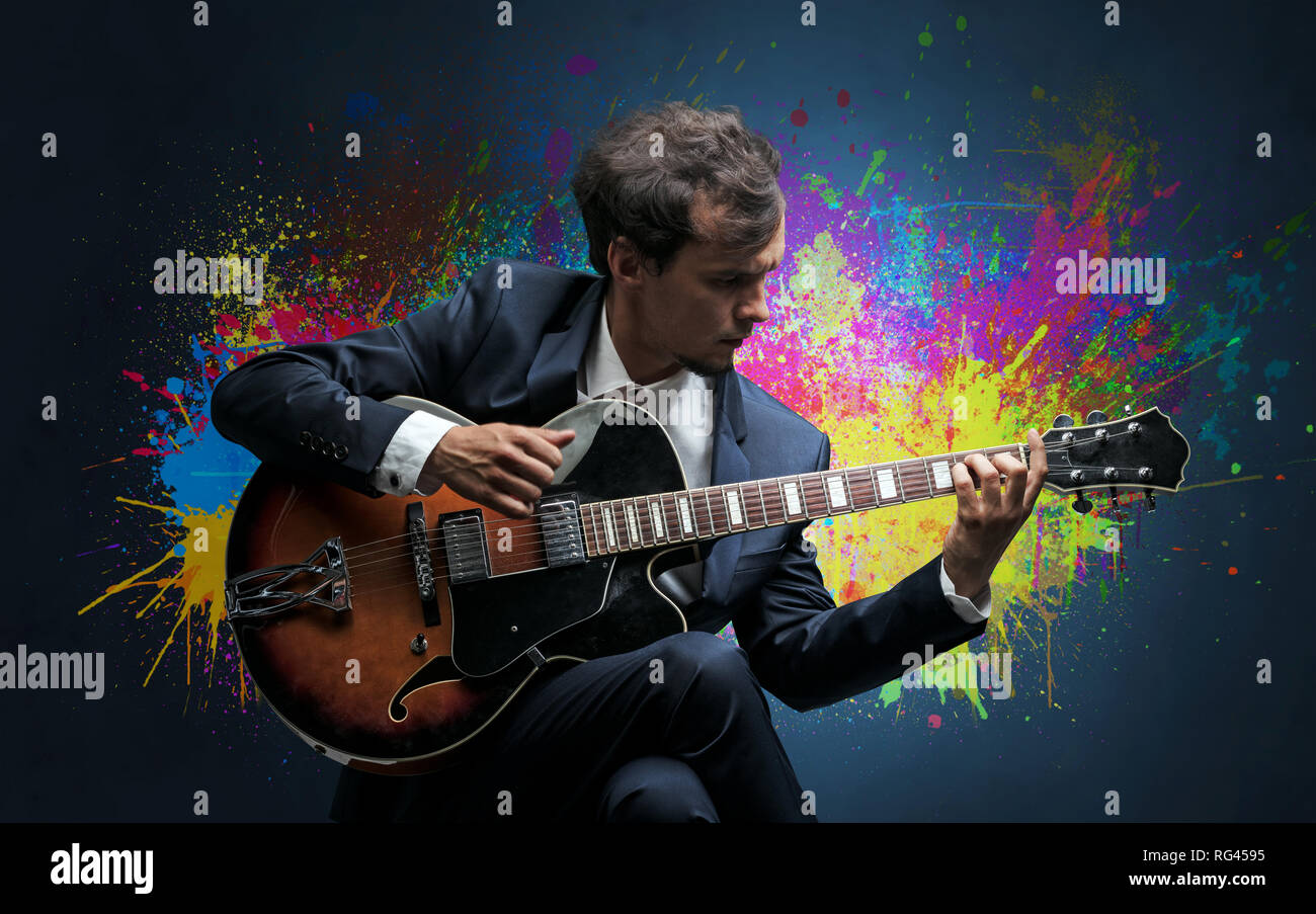 Young classical guitarist musician with colorful splotch wallpaper ...