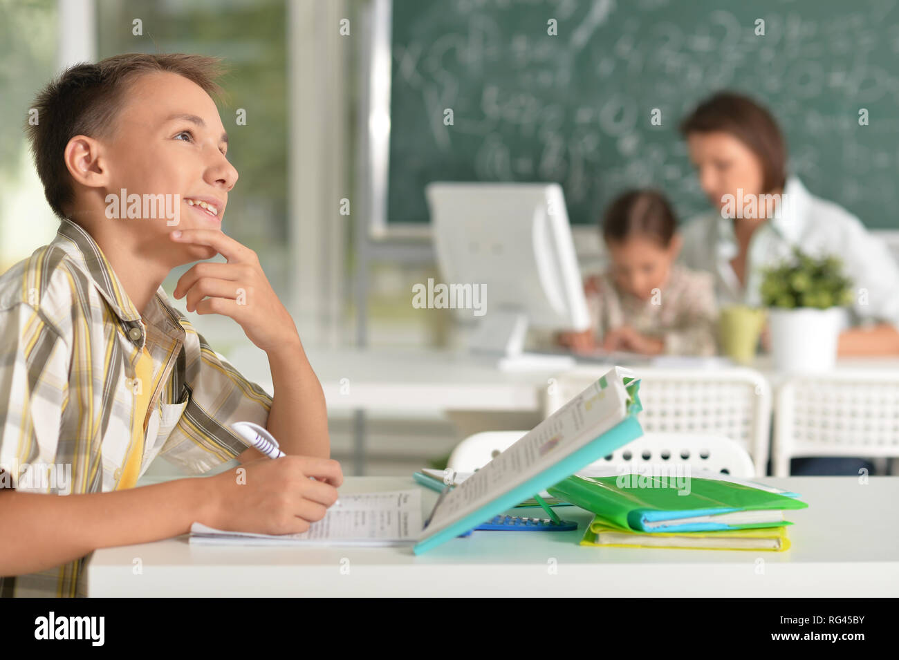Portrait of children at school in the classroom Stock Photo - Alamy