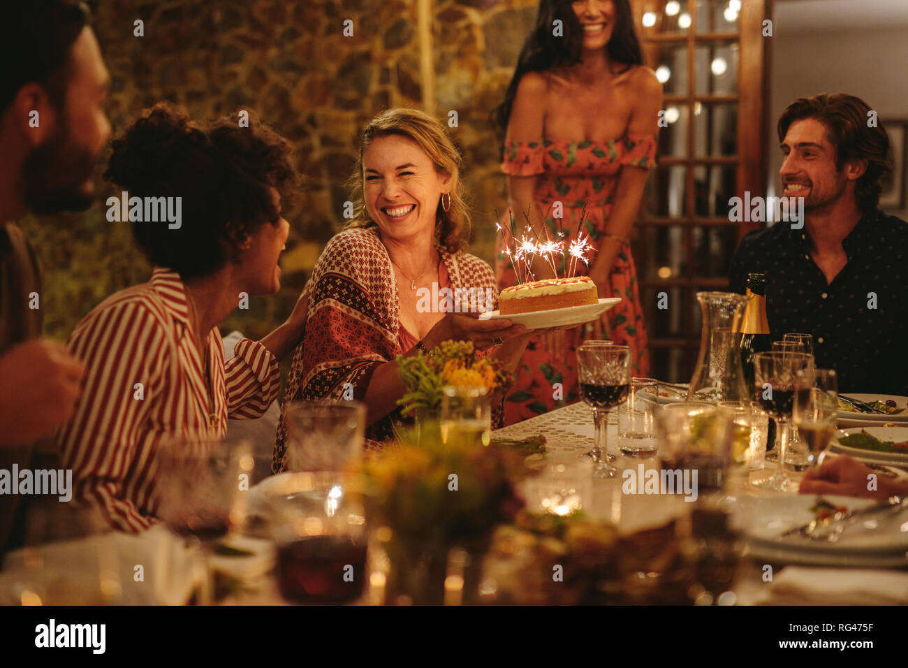 Beautiful young woman celebrating her birthday with her friends. Female ...